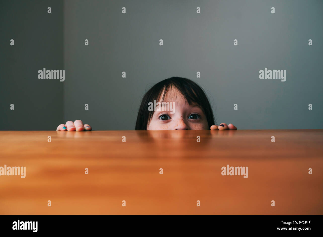 Children hiding behind table hi-res stock photography and images - Alamy