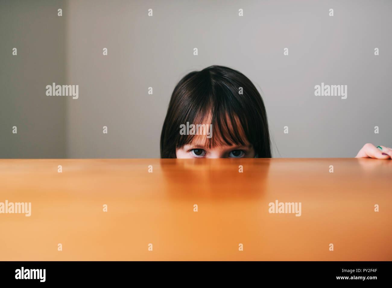 Children hiding behind table hi-res stock photography and images - Alamy
