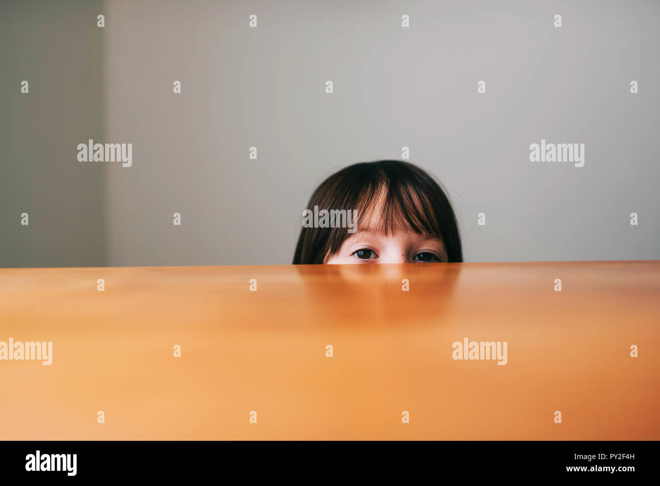 Girl standing behind table hi-res stock photography and images - Alamy