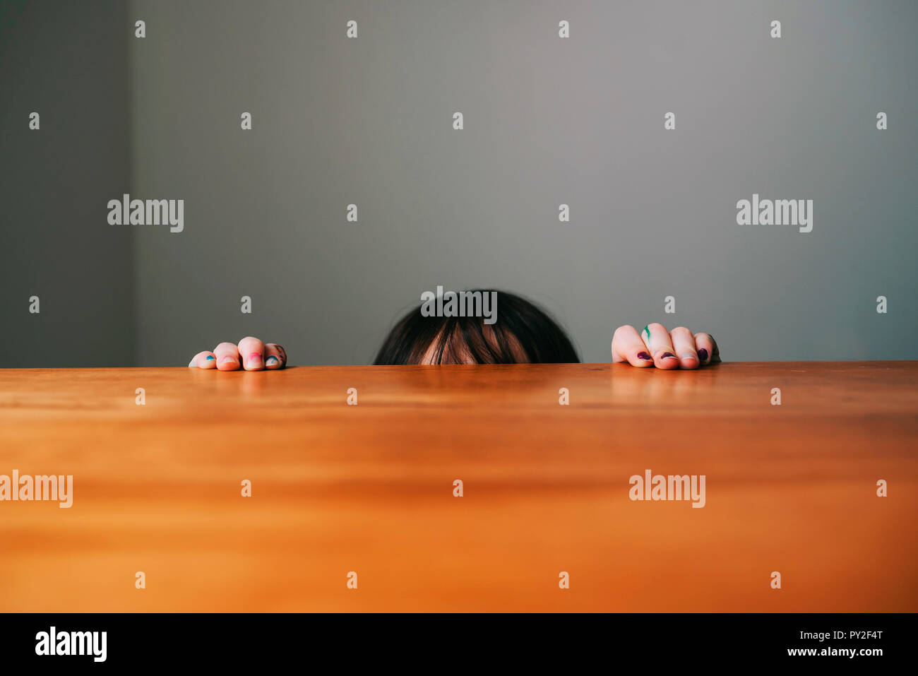 Girl standing behind table hi-res stock photography and images - Alamy