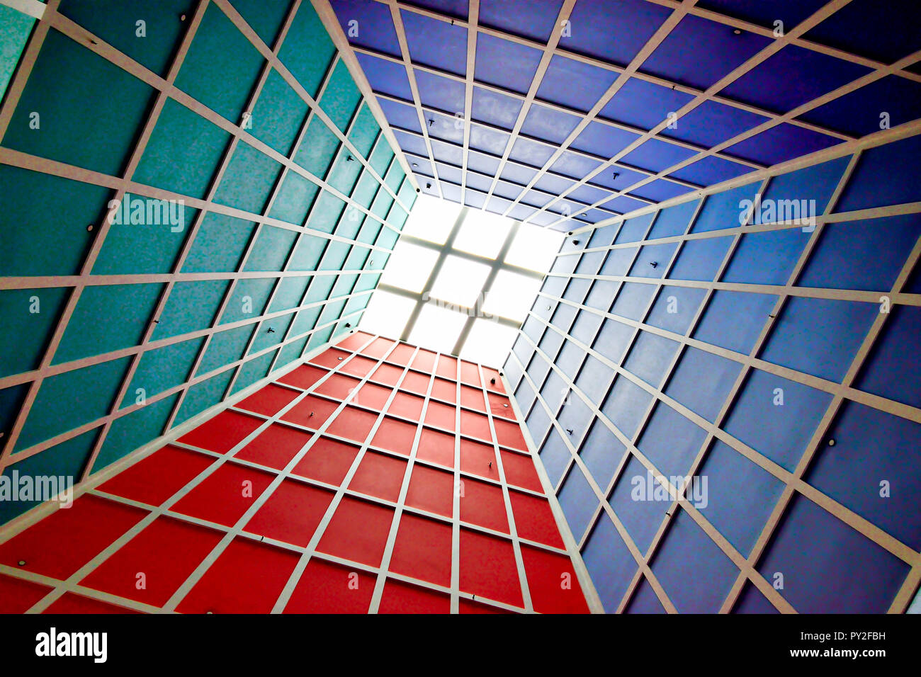 Abstract perspective of vertical lobby ceiling with skylight and strong ...