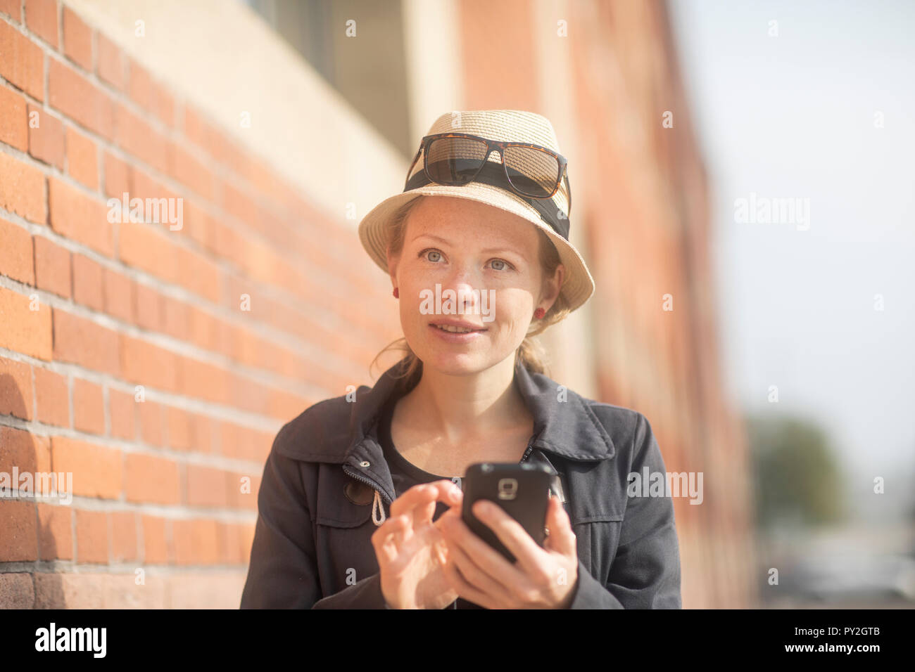 Person using mobile device on street hi-res stock photography and ...