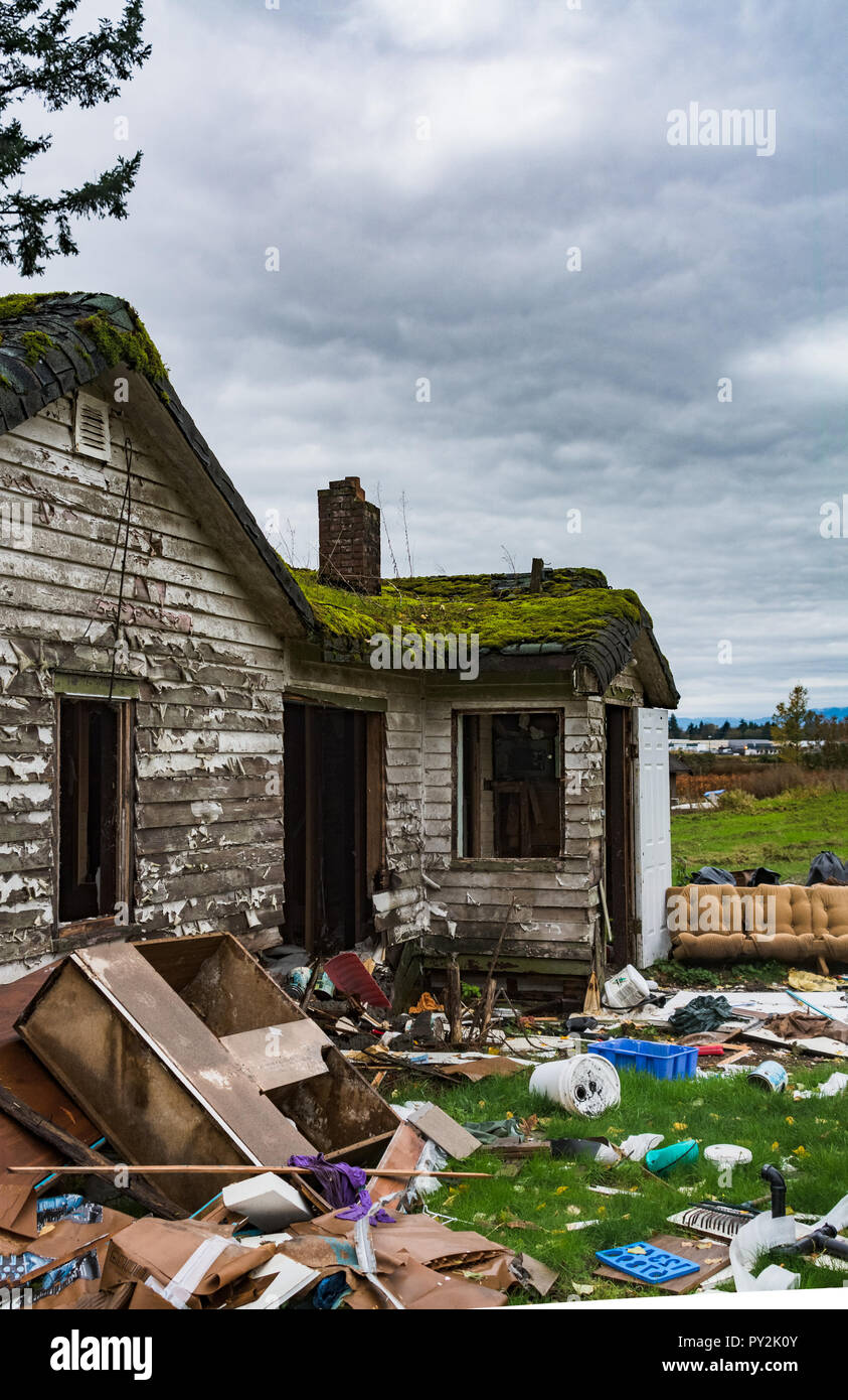 Old abandoned house in disrepair on cold fall day. Ruined house before ...