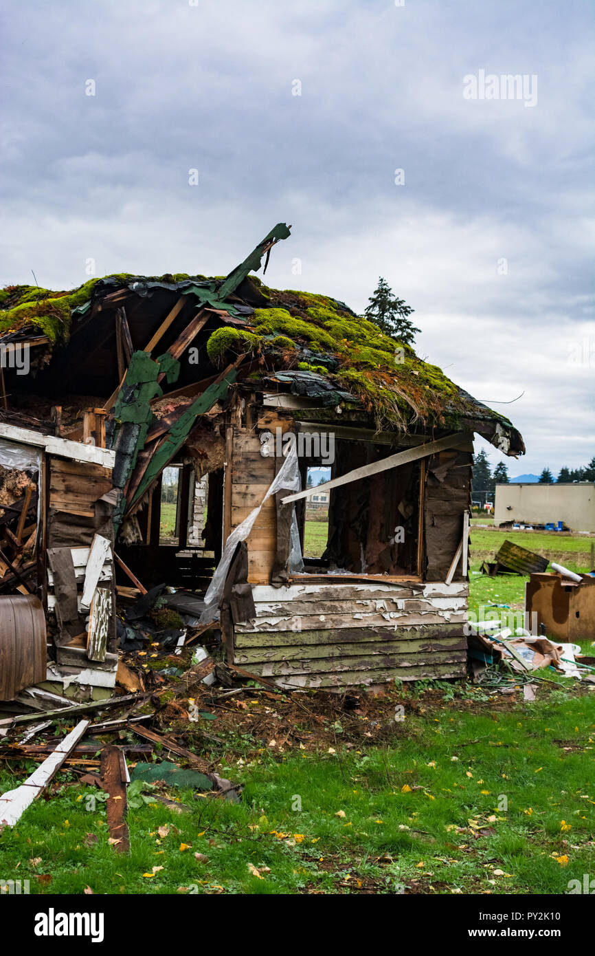 Old abandoned house in disrepair on cold fall day. Ruined house before ...