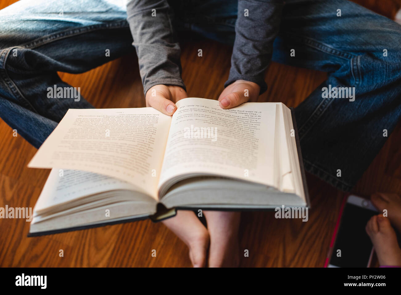 A faceless child reading a book Stock Photo - Alamy