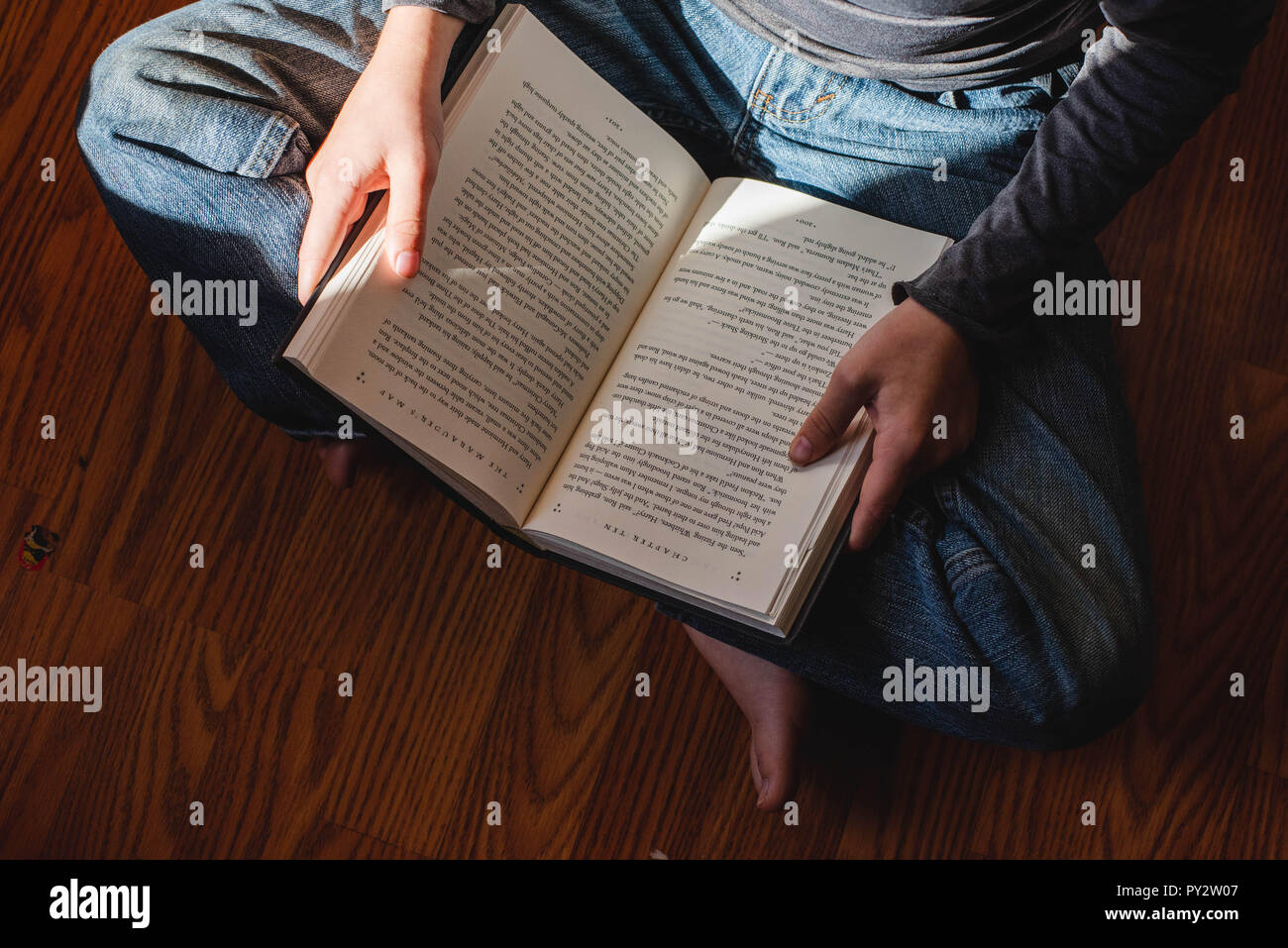 A faceless child reading a book Stock Photo - Alamy