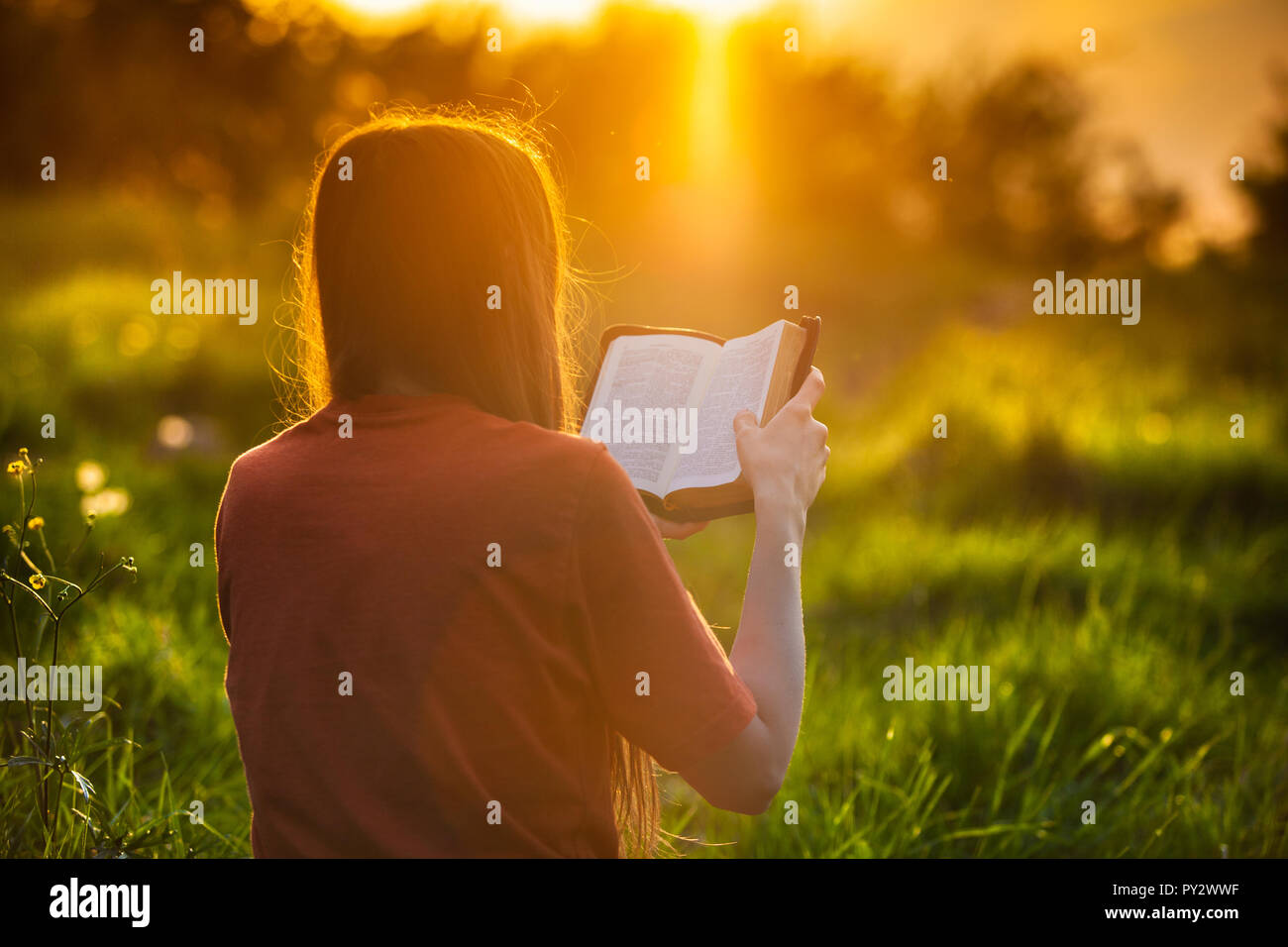 Girl reading bible hi-res stock photography and images - Alamy