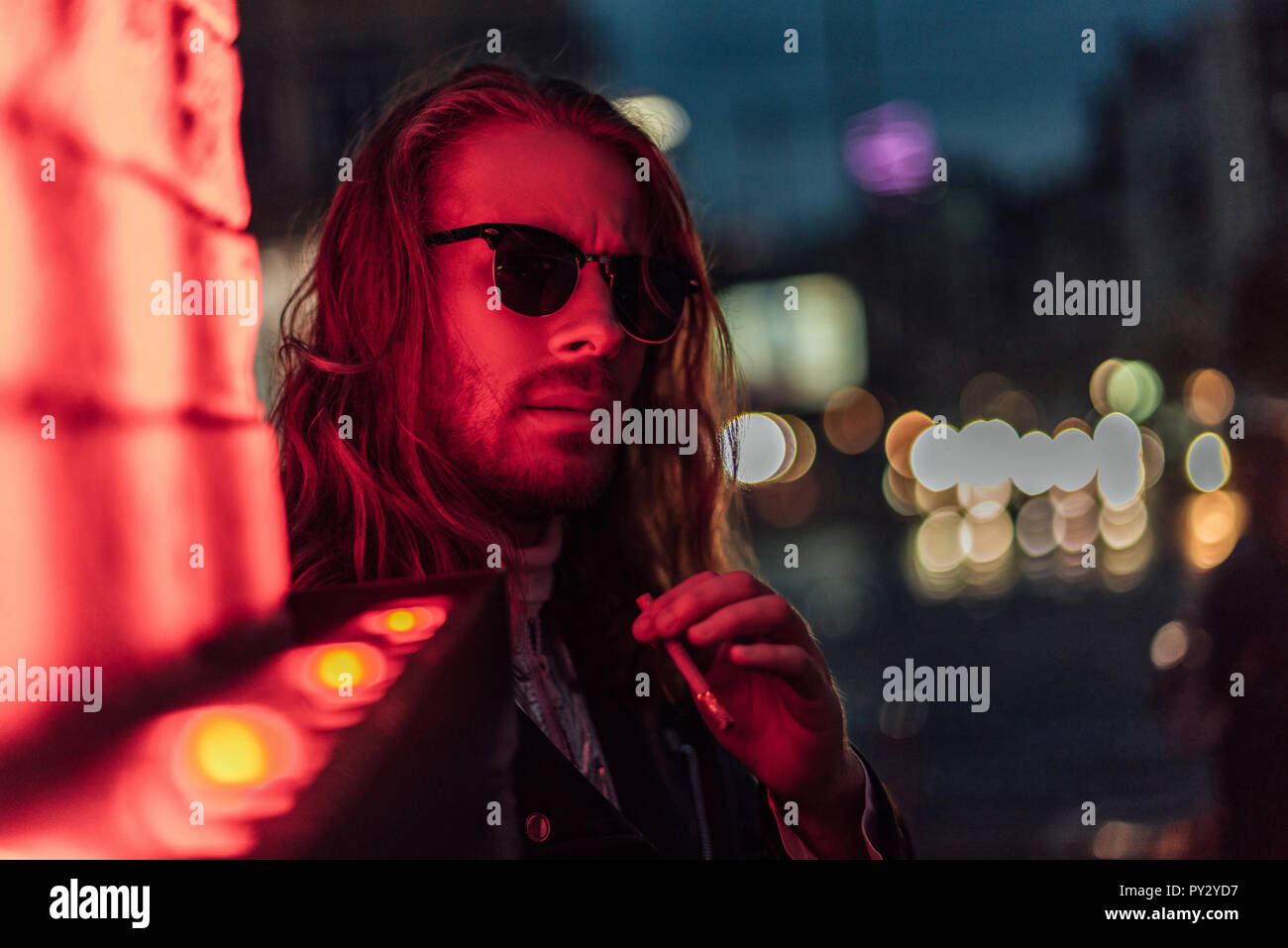 Person lights cigarette on street hi-res stock photography and images ...