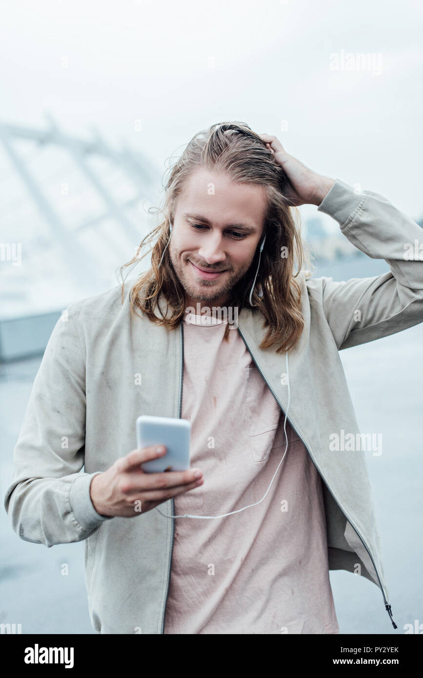 Happy young man listening music hi-res stock photography and images - Alamy