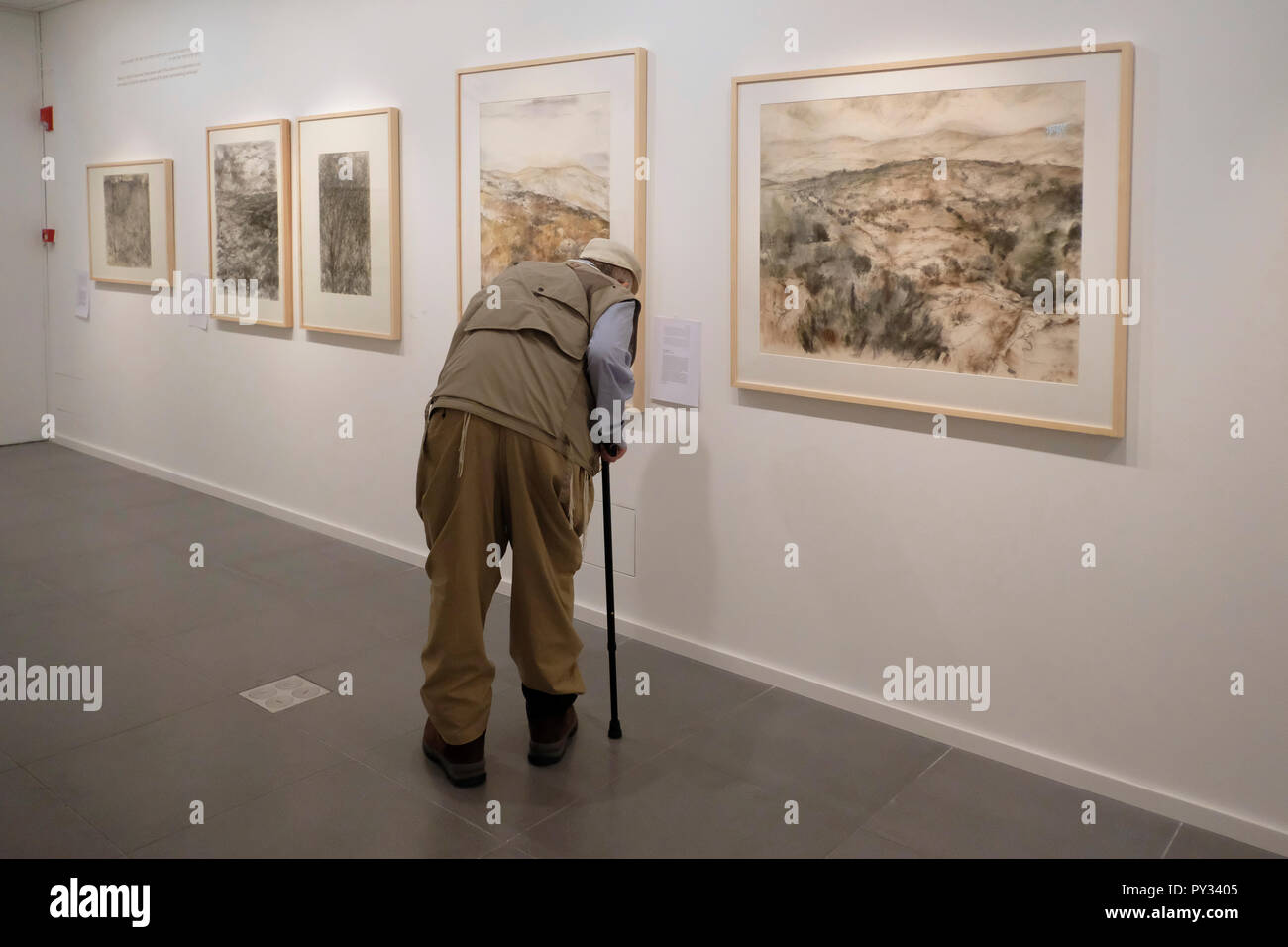 An elderly visitor looking at Anna Ticho's works displayed inside Anna ...
