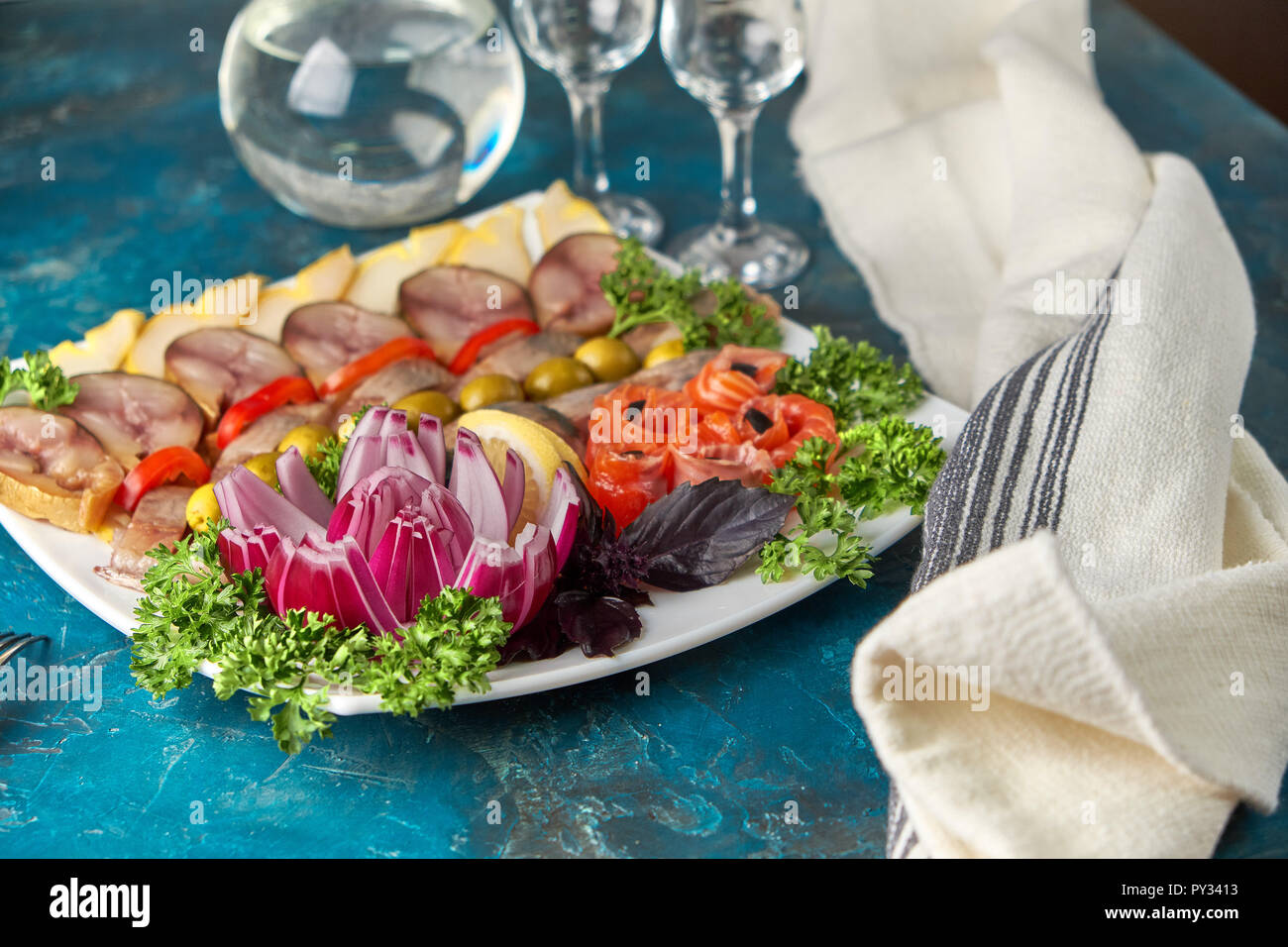 Plate with fish platter on blue background Stock Photo - Alamy