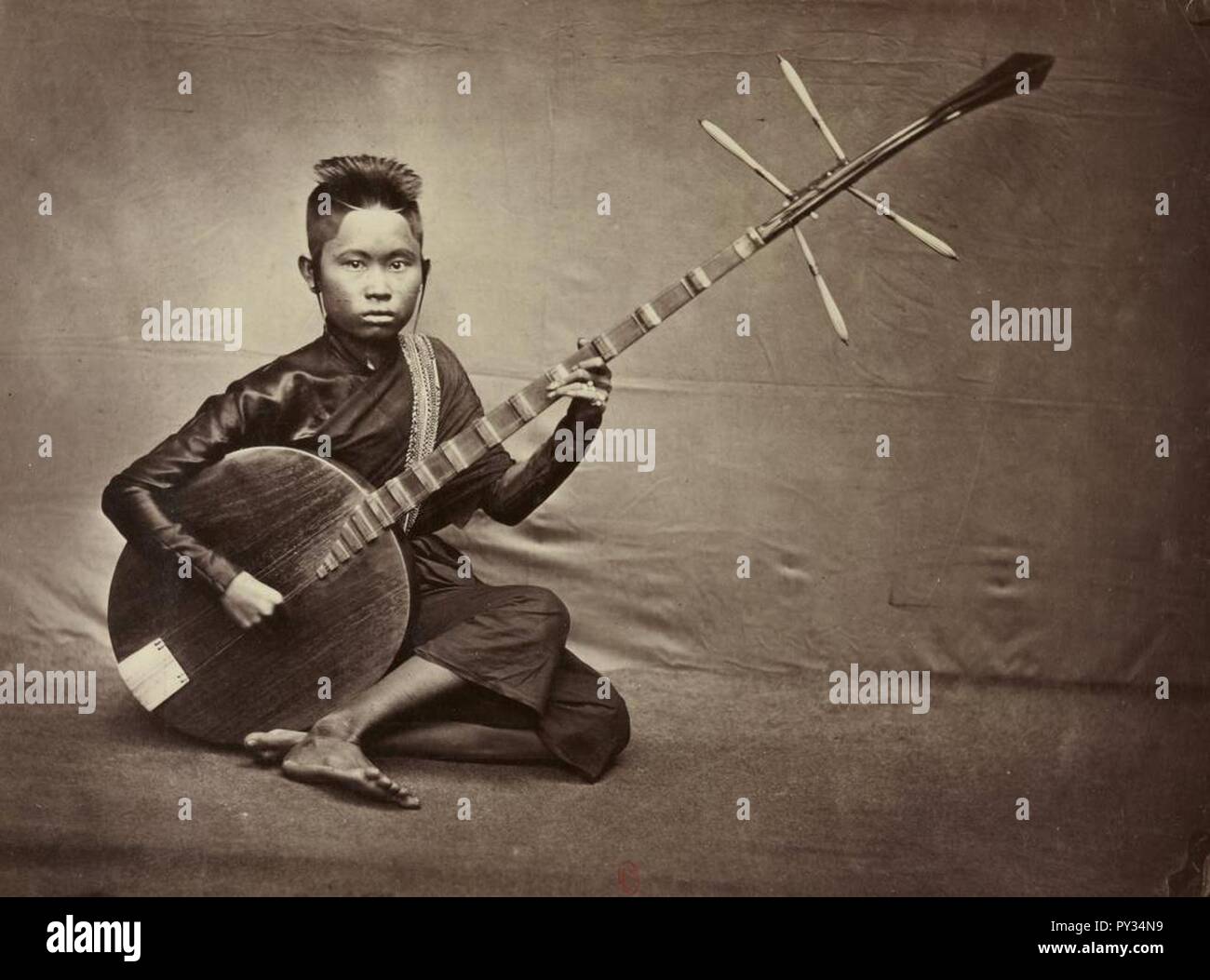 Cambodian musician playing Chapey, 1880 Stock Photo - Alamy