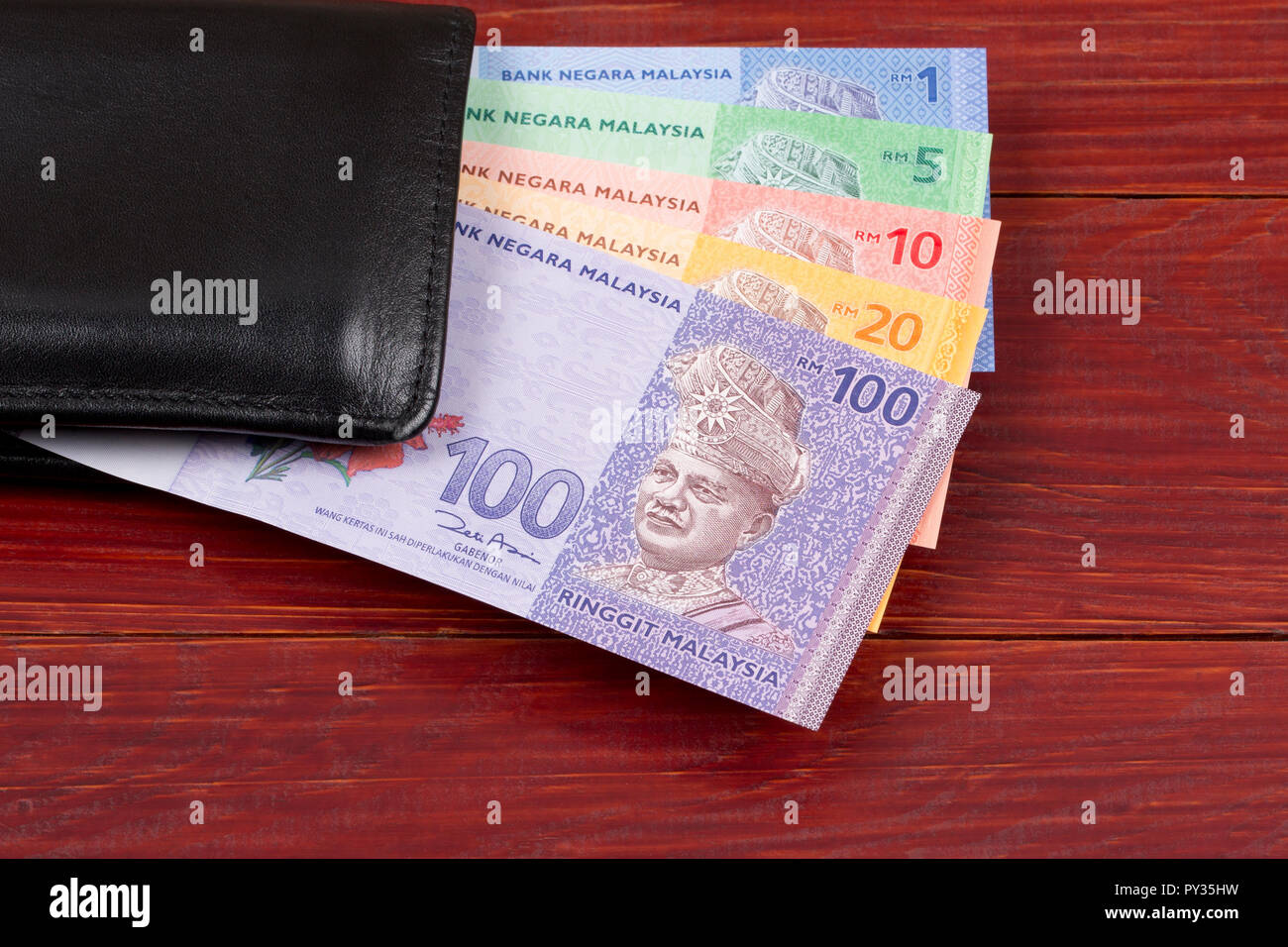 Malaysian money in the black wallet Stock Photo - Alamy