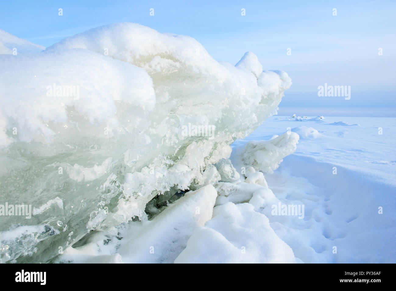 Winter landscape. Frozen lake with cracking ice Stock Photo - Alamy