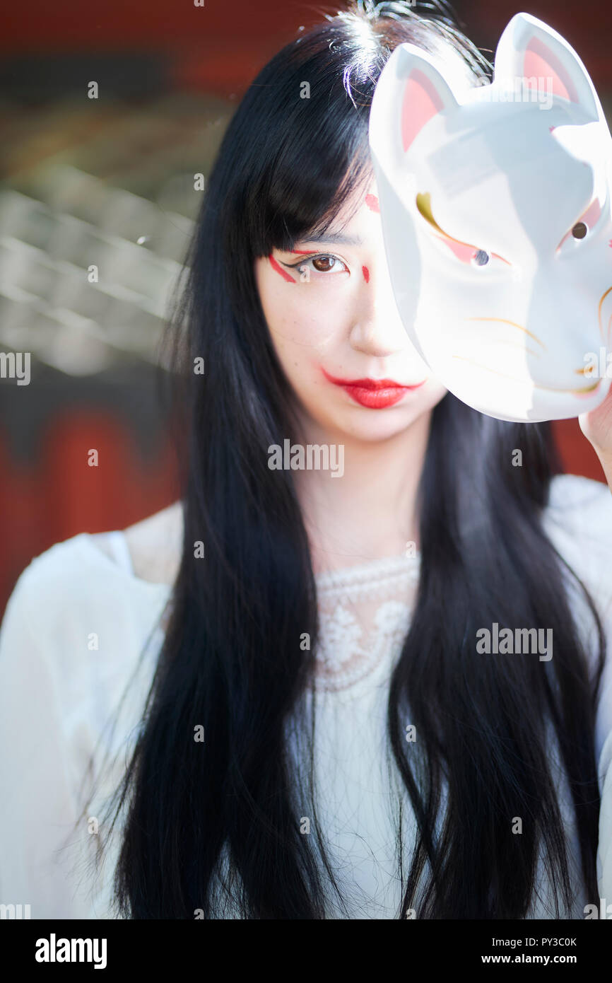 Young Japanese woman with fox mask Stock Photo - Alamy