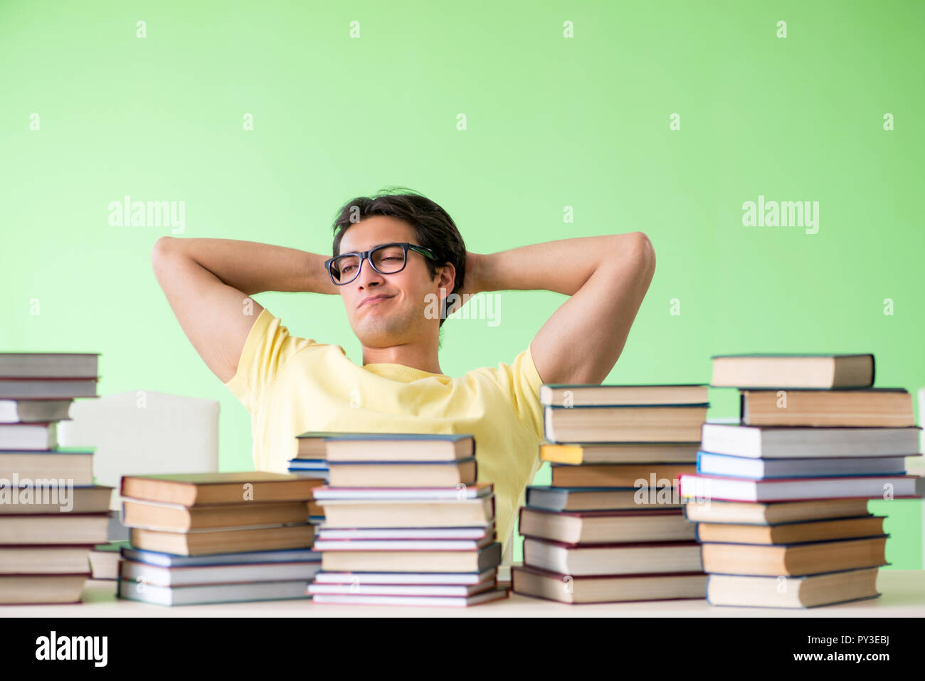 Student with too many books to read before exam Stock Photo - Alamy