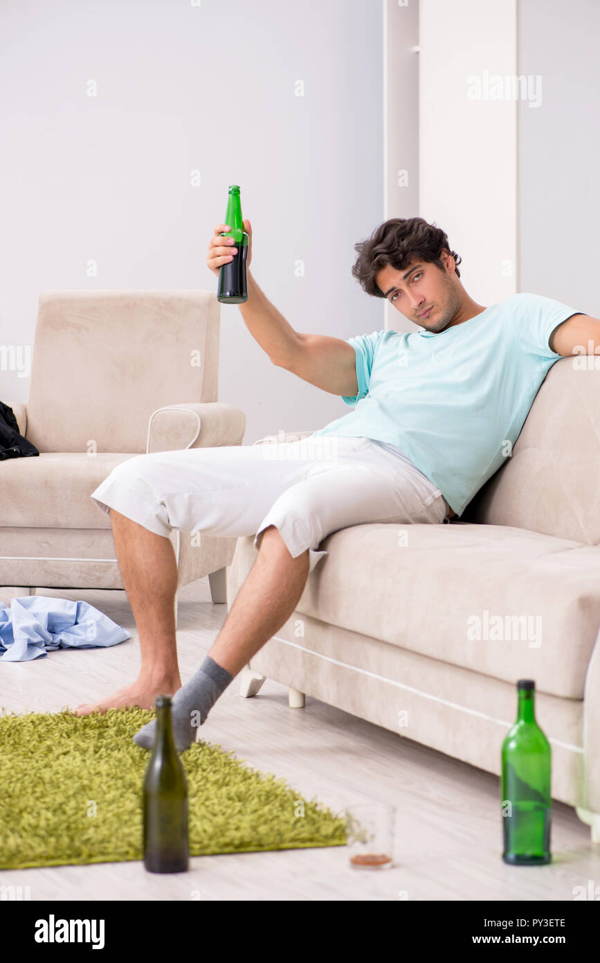 Young drunk handsome man after party at home Stock Photo - Alamy