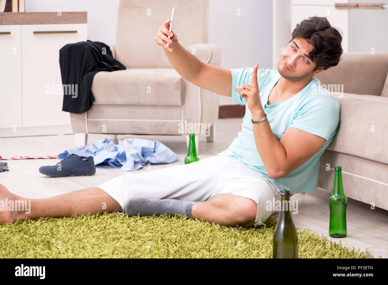 Young drunk handsome man after party at home Stock Photo - Alamy