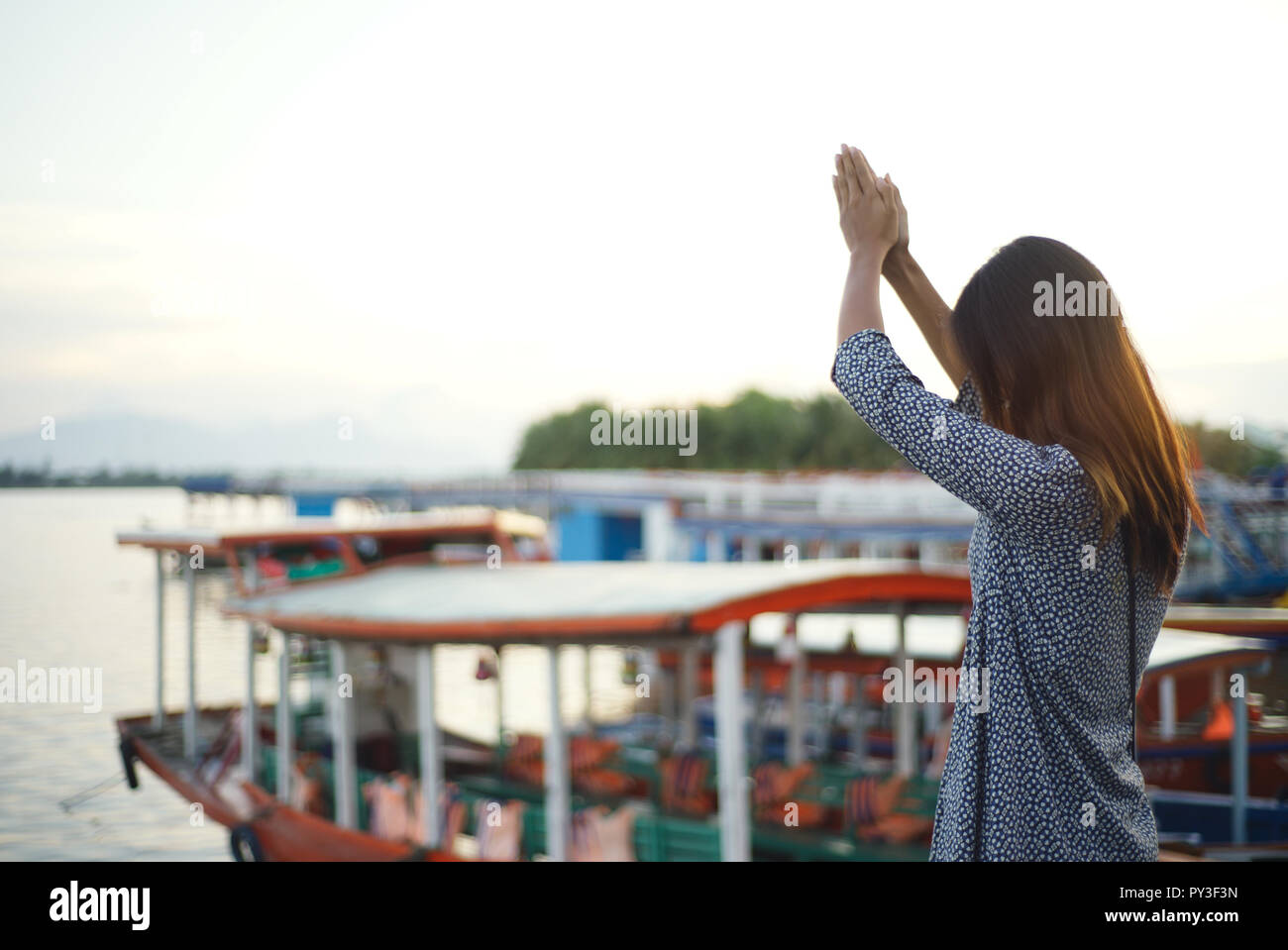 Woman praying near water hi-res stock photography and images - Alamy
