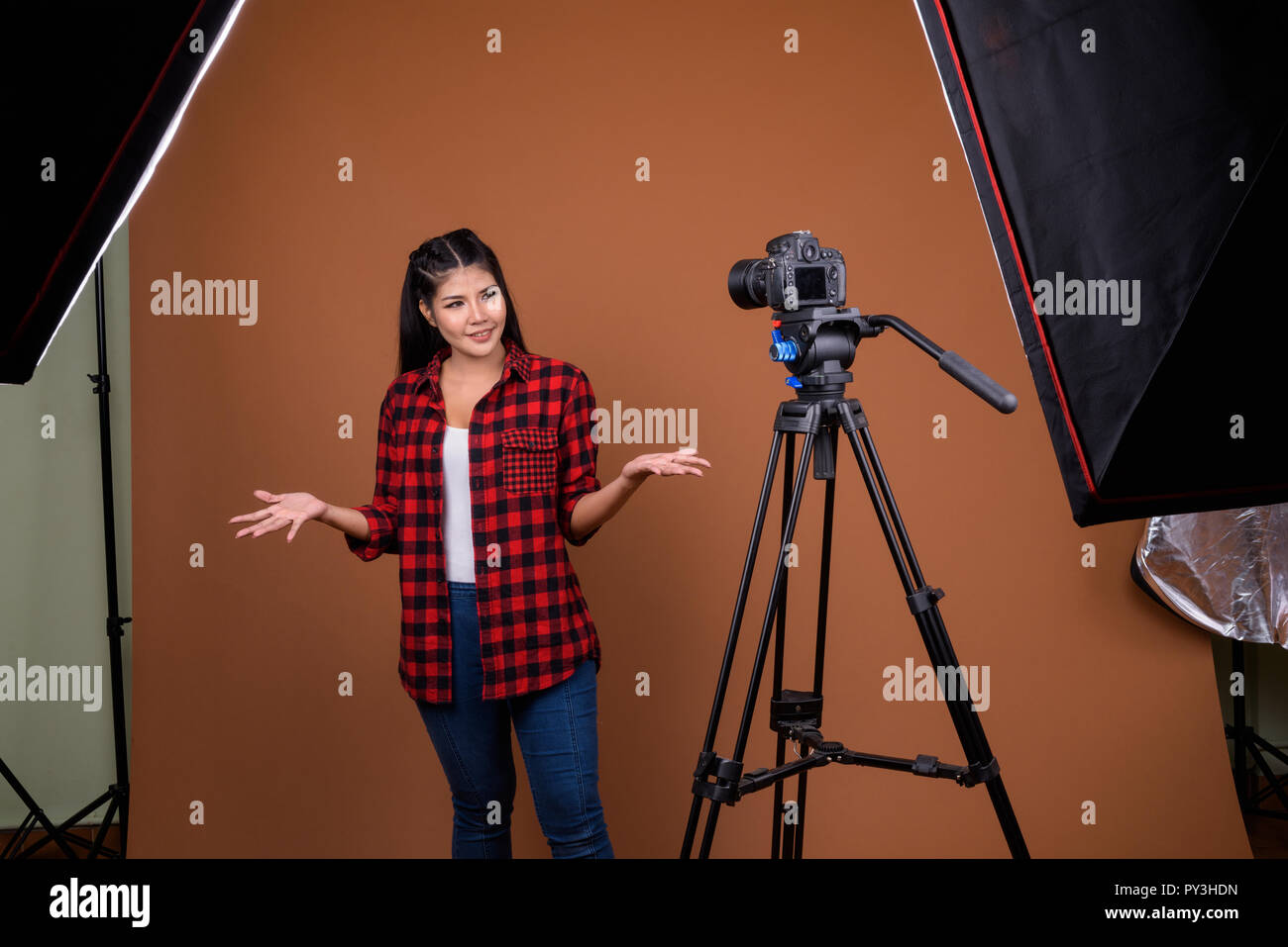 Young Asian woman vlogging in studio with camera on tripod Stock Photo ...