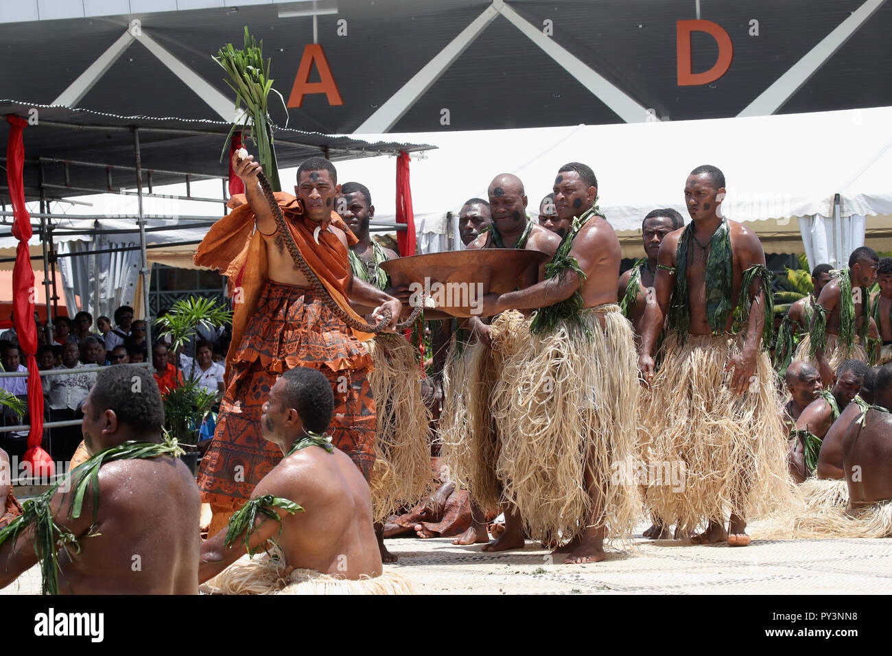 Locals in traditional dress attend the attend the unveiling of a statue ...