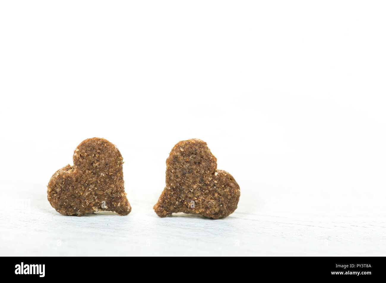 Heart shaped dog kibble on a white background with space for copy Stock ...