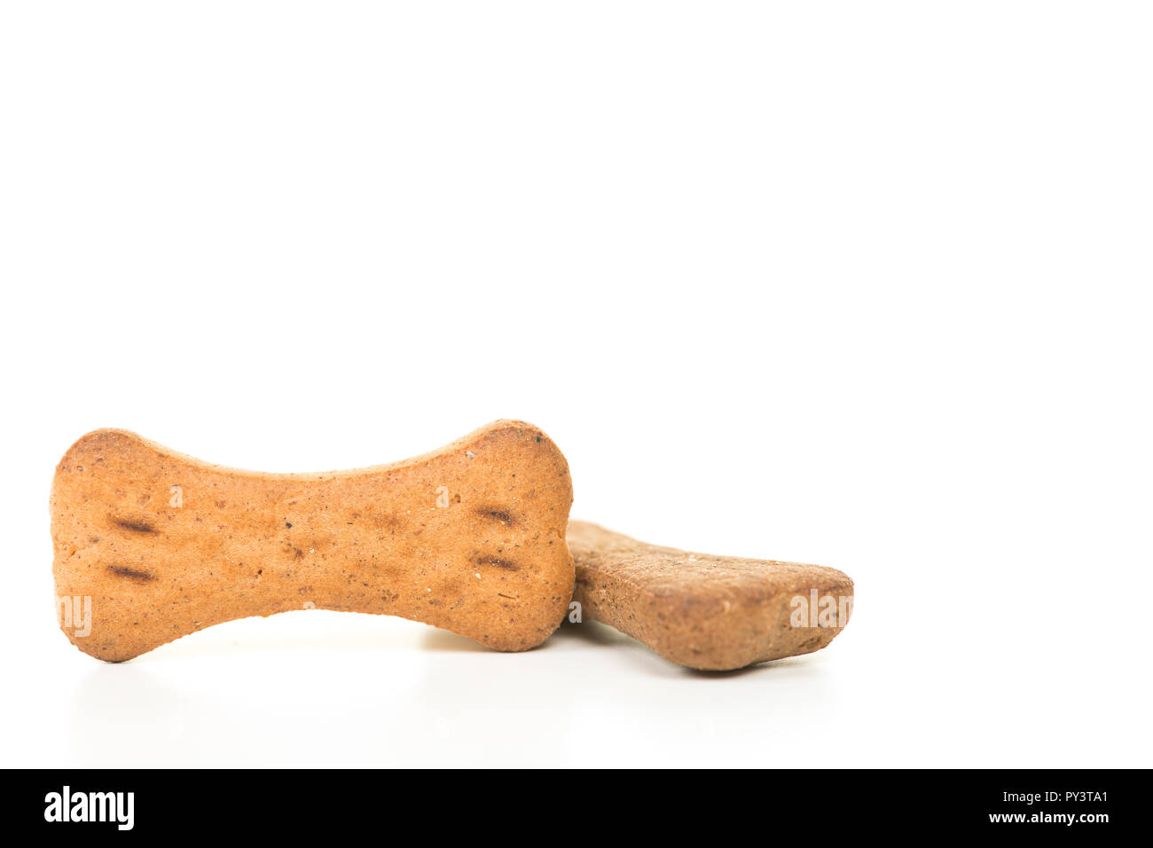 Brown bone shaped dog cookies isolated on a white background with space ...