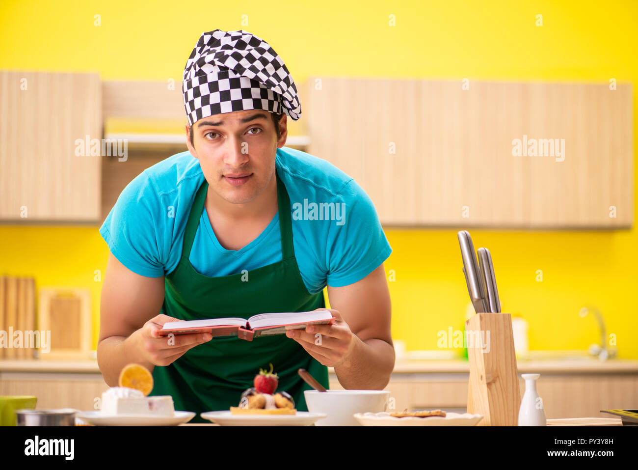 Male chef reading cookbook preparing hi-res stock photography and ...