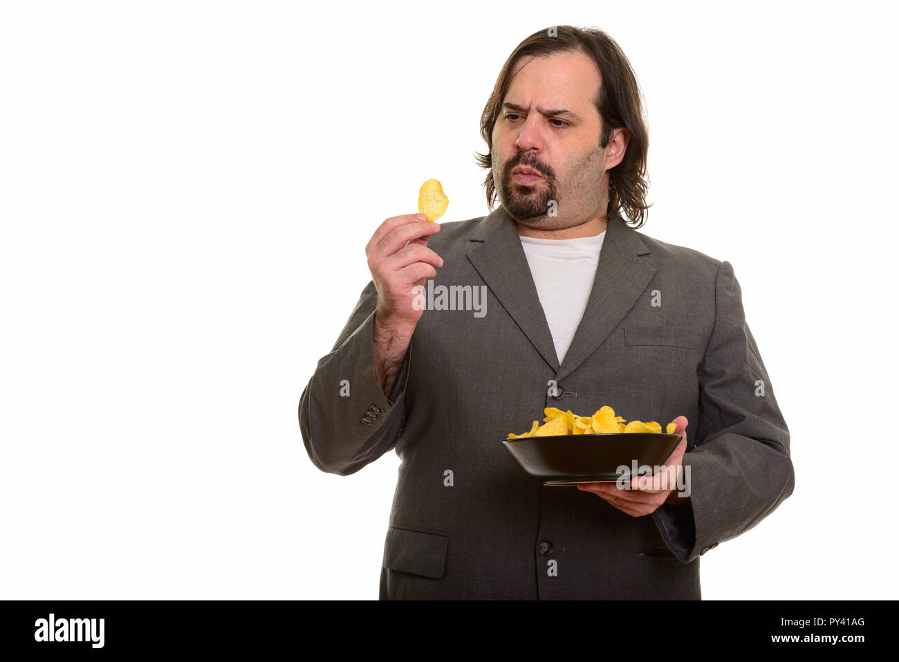 Fat Caucasian businessman holding bowl of chips and thinking Stock ...
