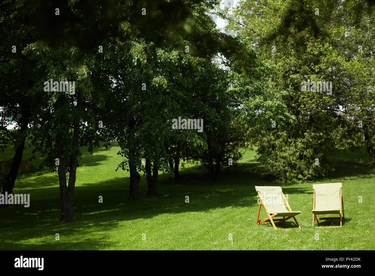 Rest chairs in the garden. Resort concept Stock Photo - Alamy