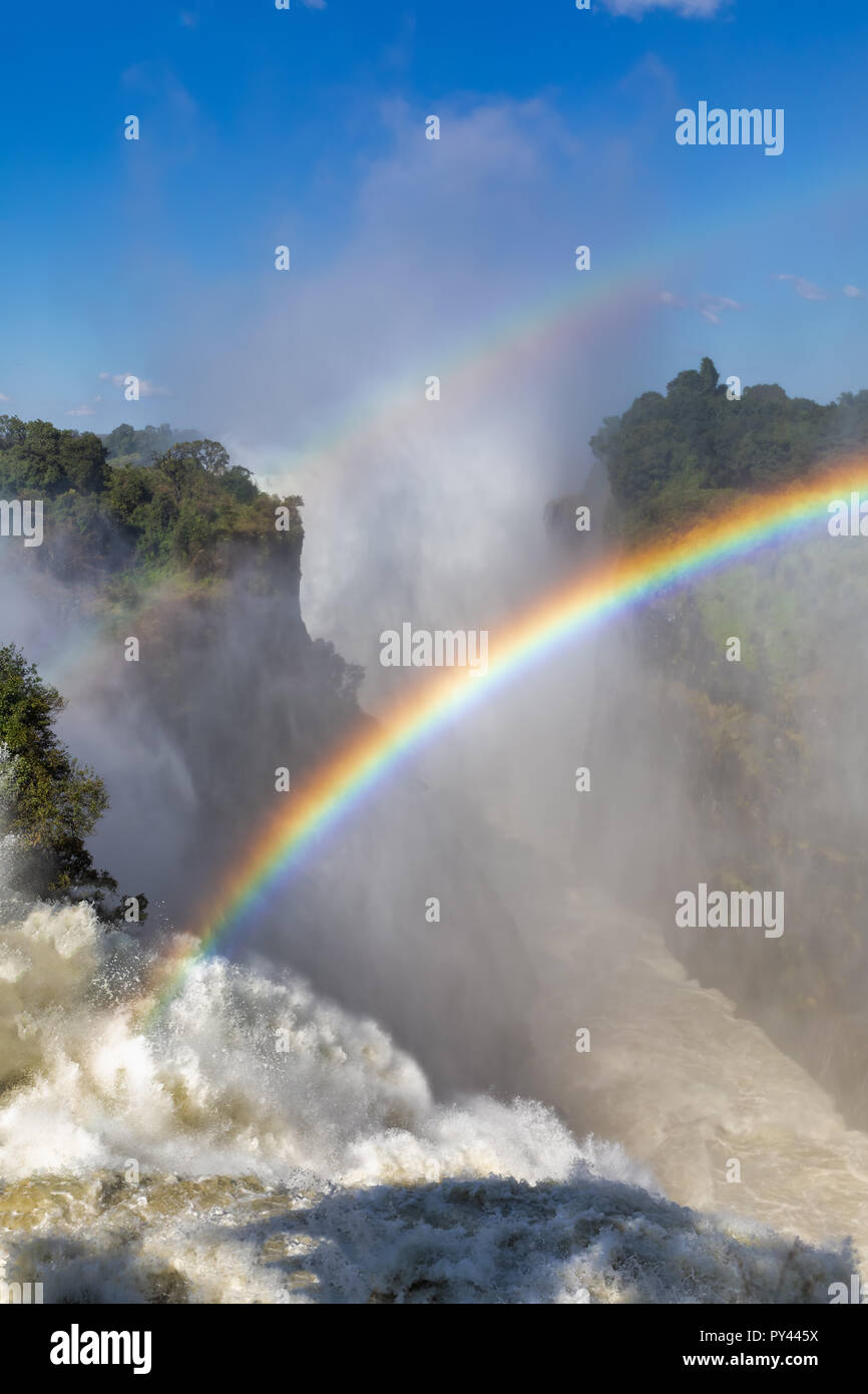 Rainbow on Victoria falls after rain season in May, waterfall is full ...
