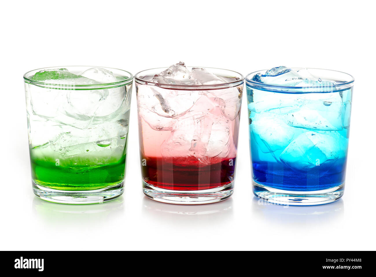 green, blue and red drink with ice cubes on white background, isolated ...