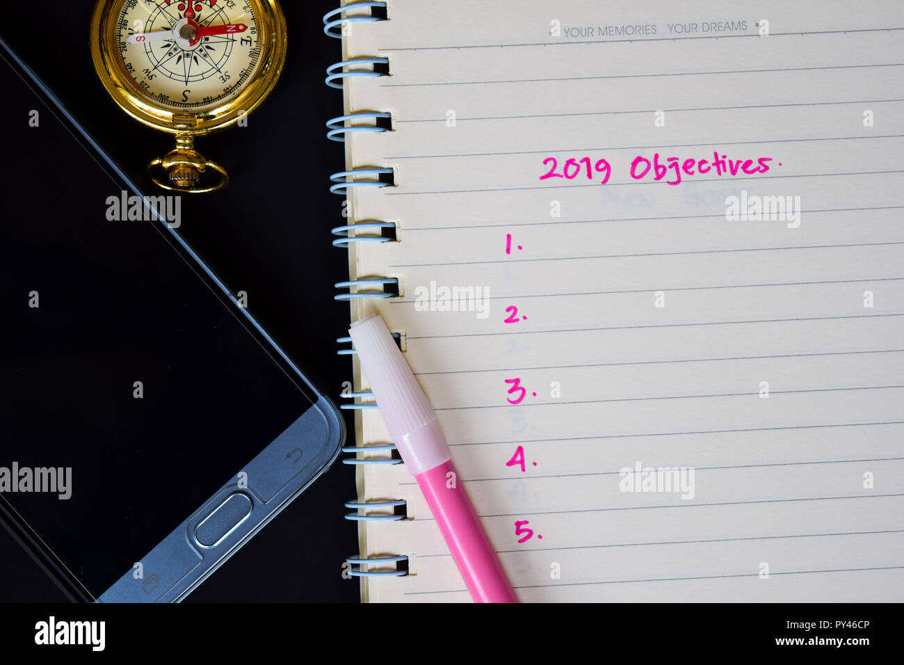 2019 Objectives text on notebook, compass, color pencil, smartphone on ...