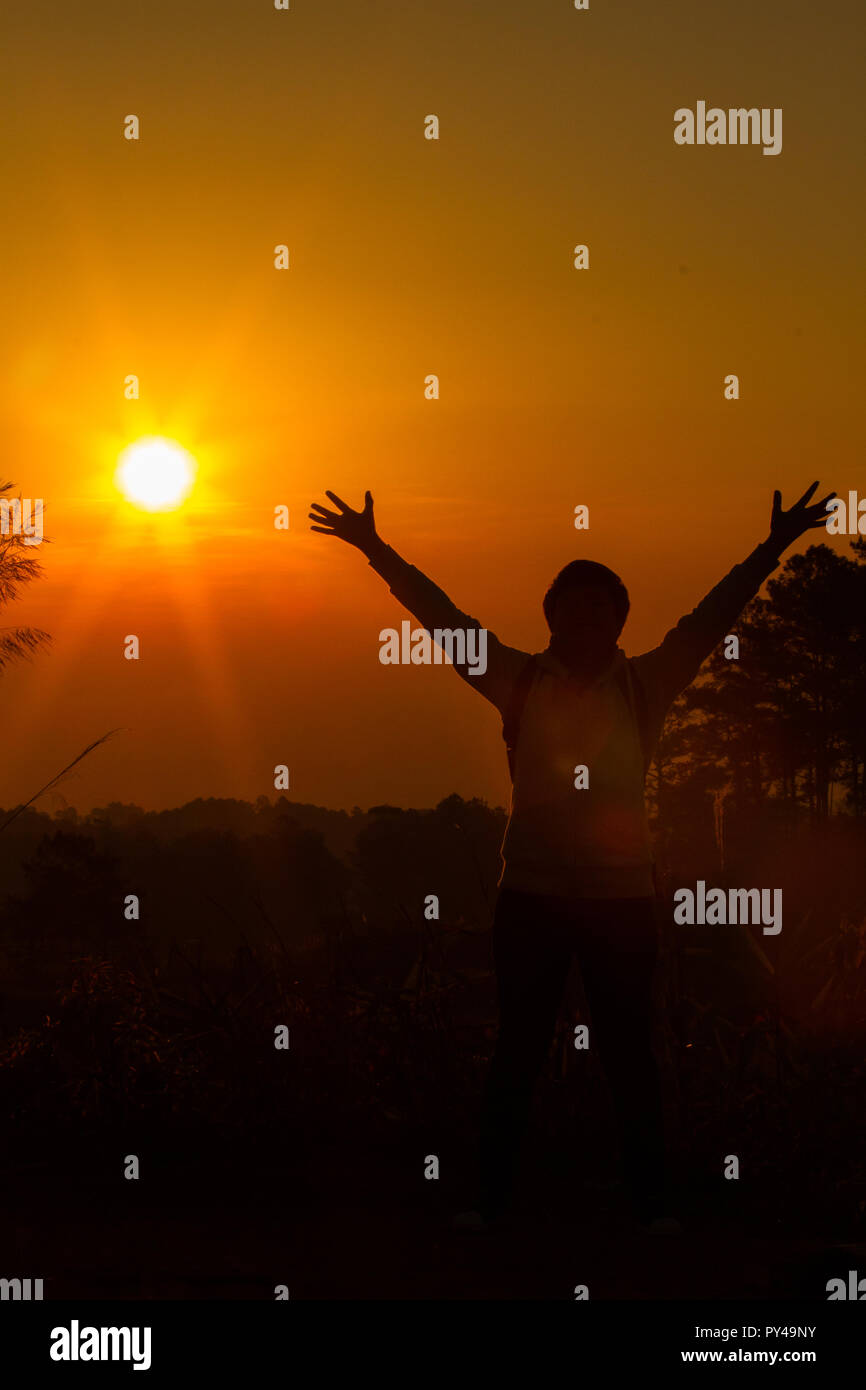silhouette of a man and beautiful sunset background Stock Photo - Alamy