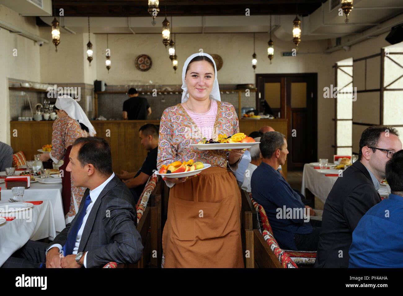 At Crimean Tatar restaurant: waitress in Tatar native dress going ...