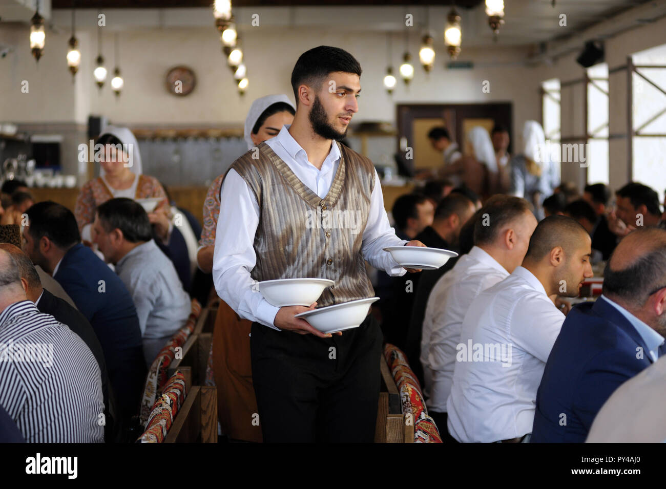 At Crimean Tatar restaurant: waiter in Tatar native dress going through ...