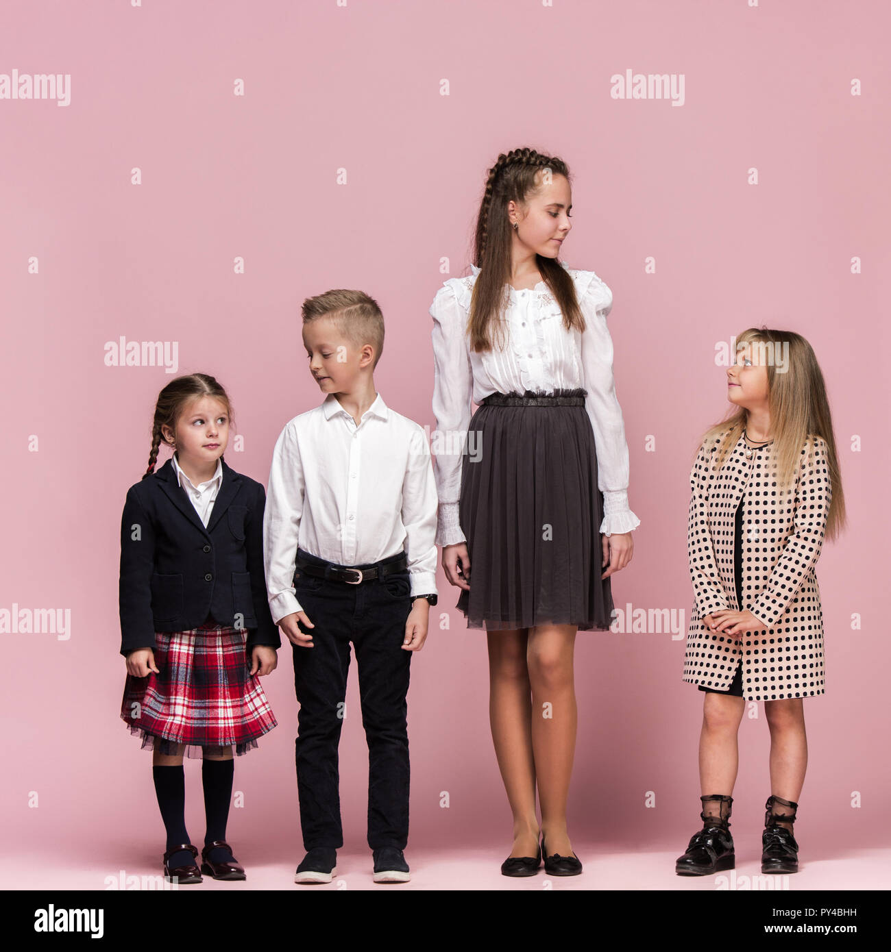 Cute smiling happy stylish children on pink background. Beautiful ...