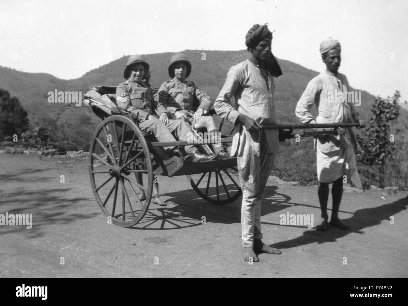 British Army Medical soldiers posing in a rickshaw tended by two Indian ...