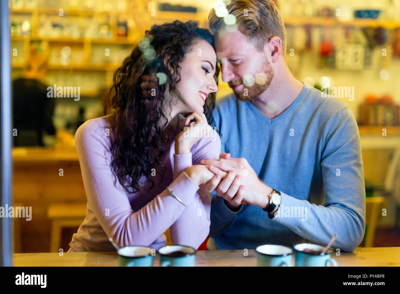 Romantic couple having date in coffee shop Stock Photo - Alamy