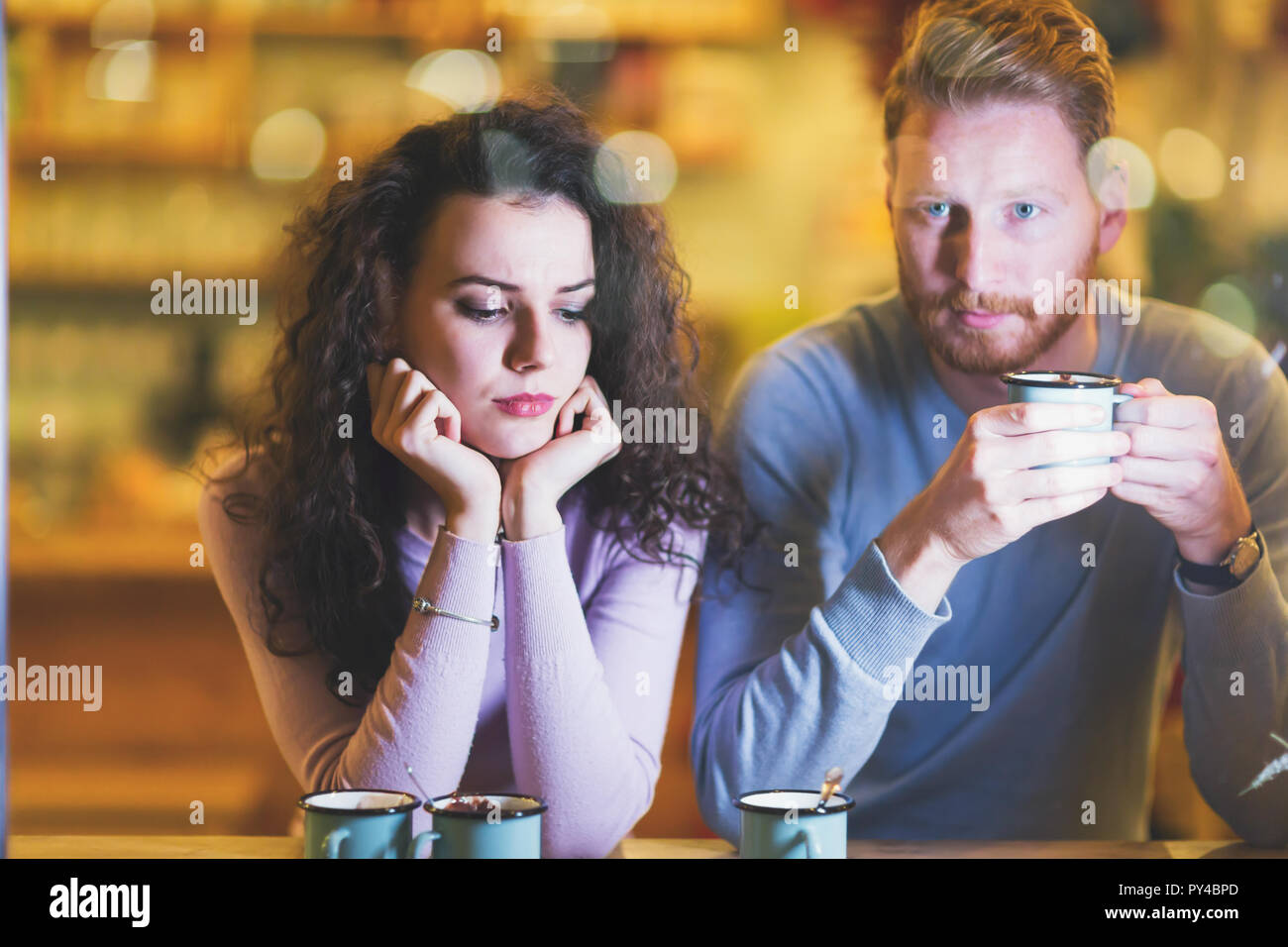 Young attractive couple having problems on date Stock Photo - Alamy