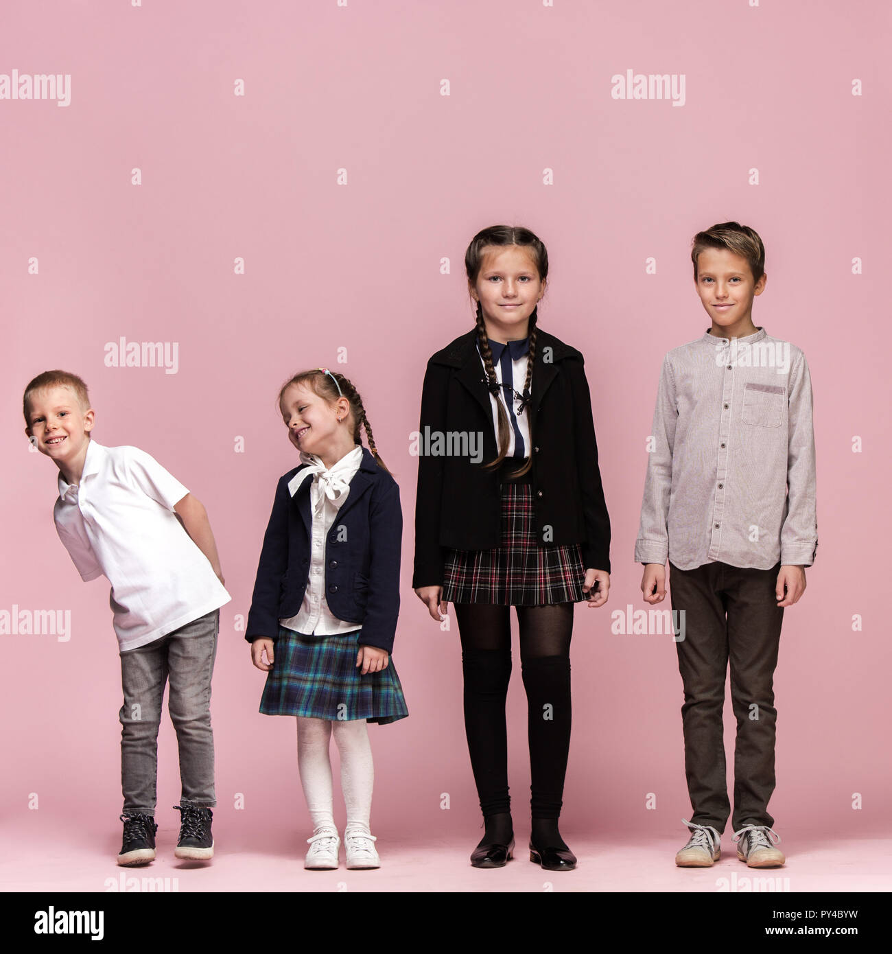 Cute smiling happy stylish children on pink background. Beautiful ...