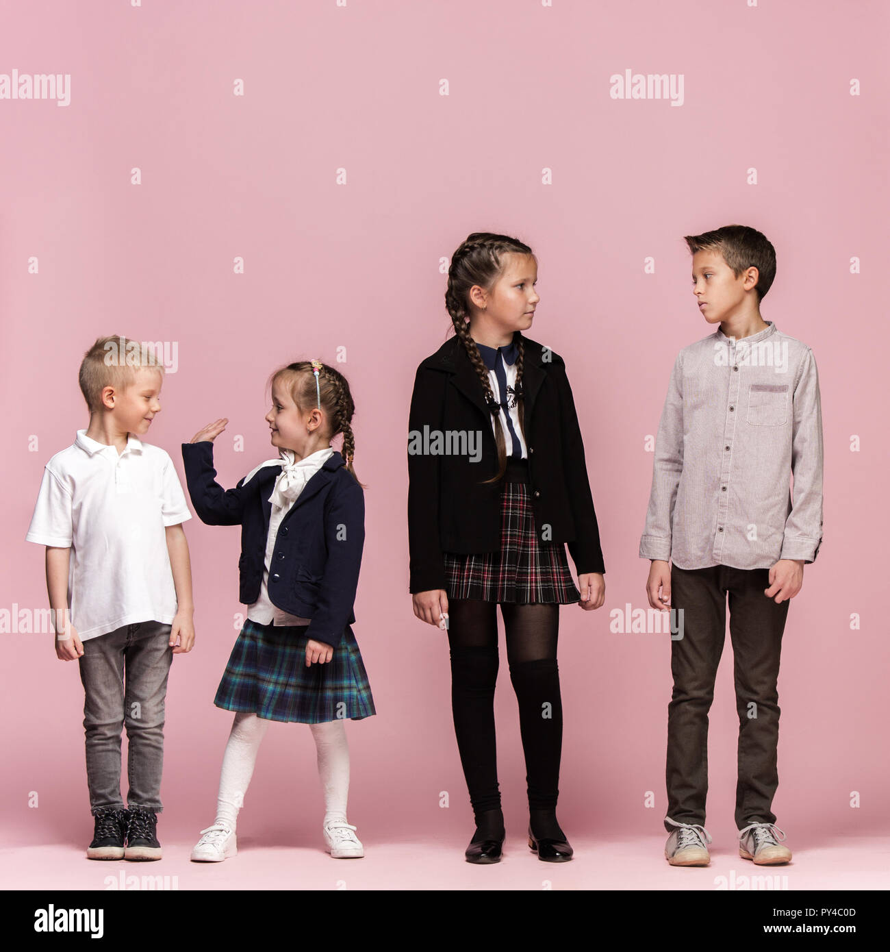 Cute smiling happy stylish children on pink background. Beautiful ...