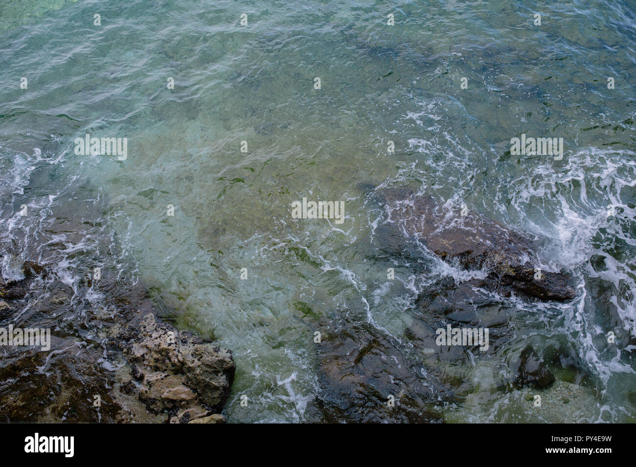 Sea and stones in Monaco blue water and waves Stock Photo - Alamy