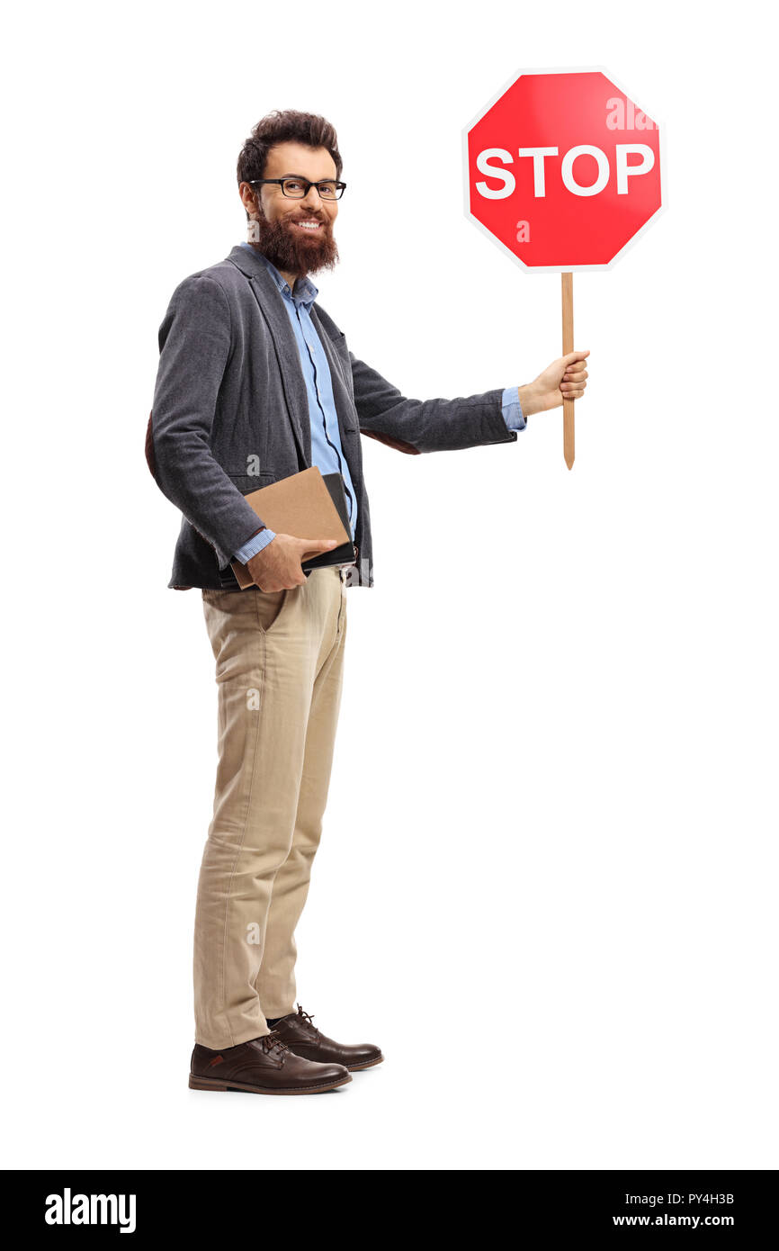 Full length studio shot of a man holding books and stop sign isolated ...