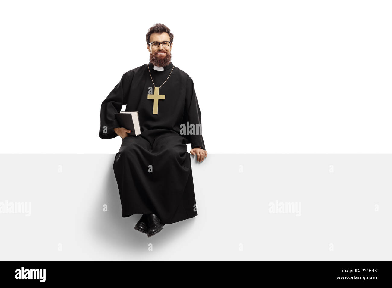 Catholic priest holding holy bible hi-res stock photography and images ...