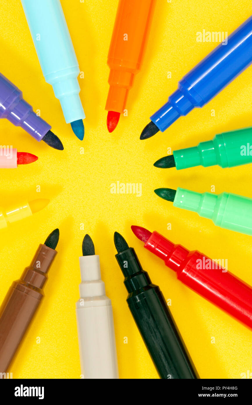 set of felt pens isolated on a yellow background Stock Photo - Alamy