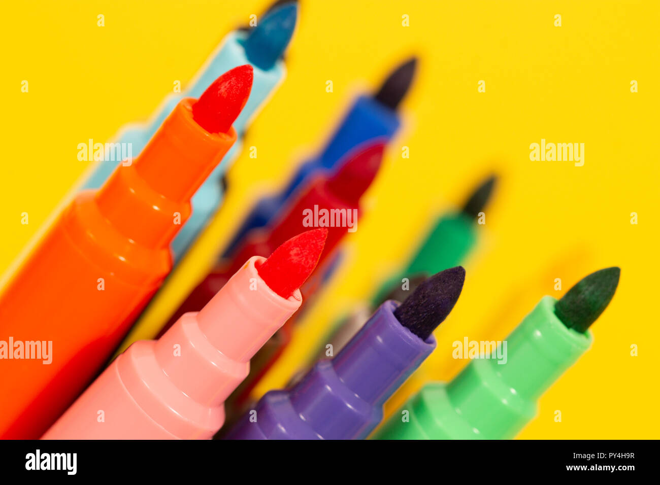 set of felt pens isolated on a yellow background Stock Photo - Alamy