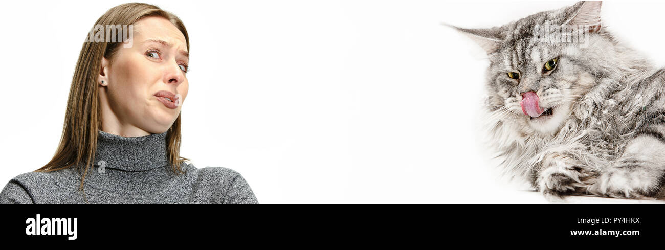 The surprised and indignant woman and her cat over white background at ...