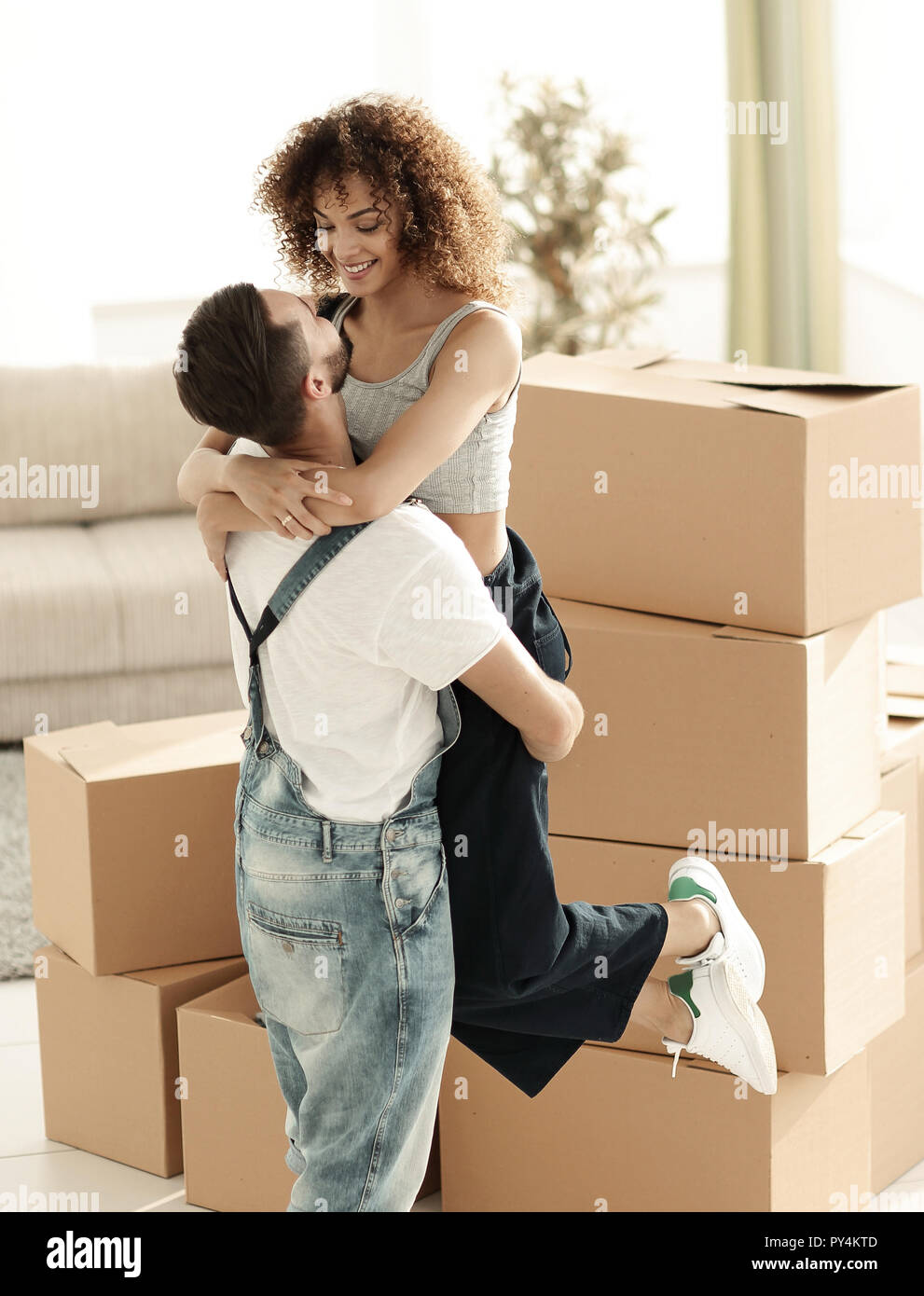 Hugging couple, against the background of boxes Stock Photo - Alamy