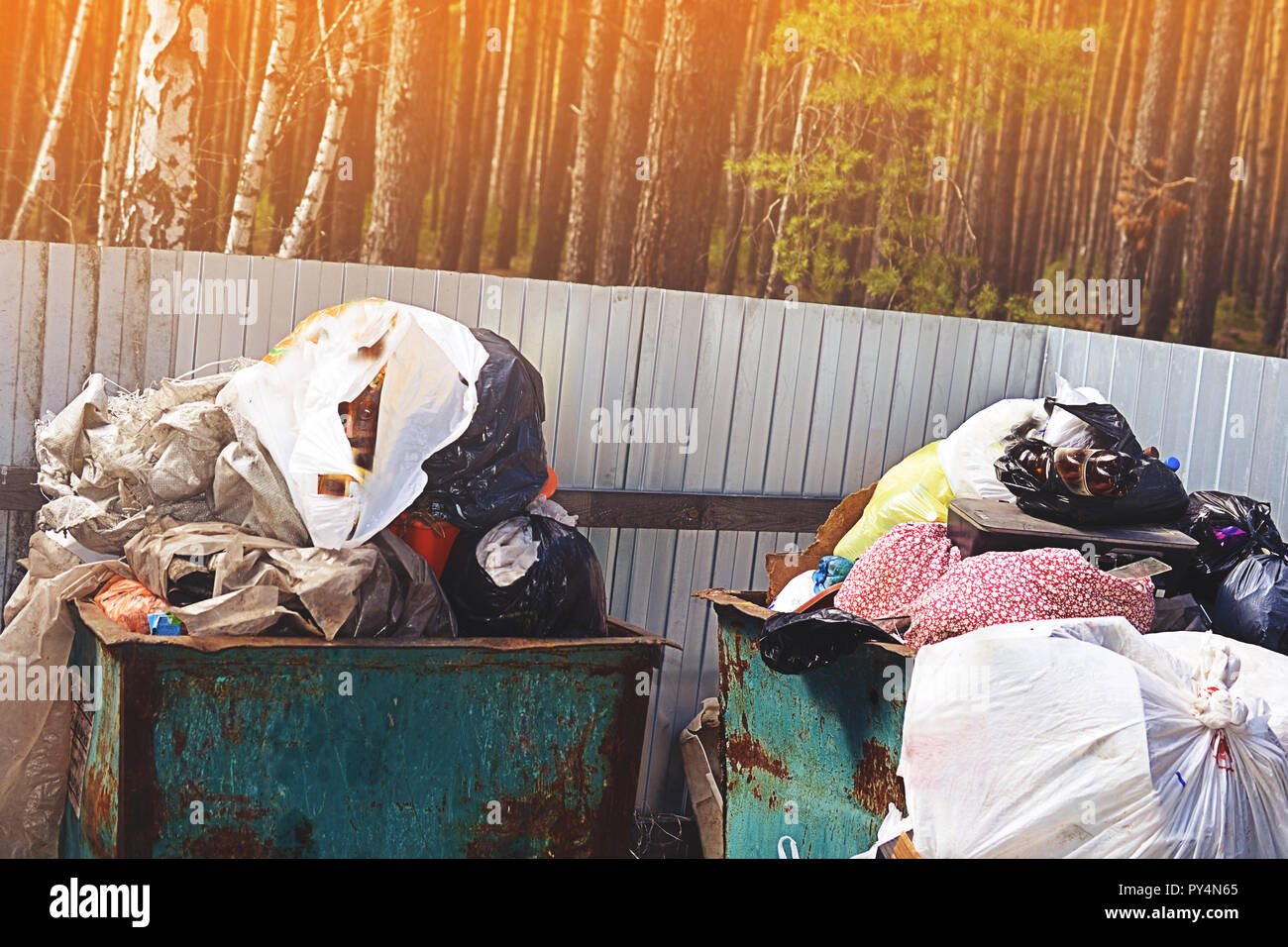 Litter box full of garbage in forest. Concept of ecology problem. Toned ...
